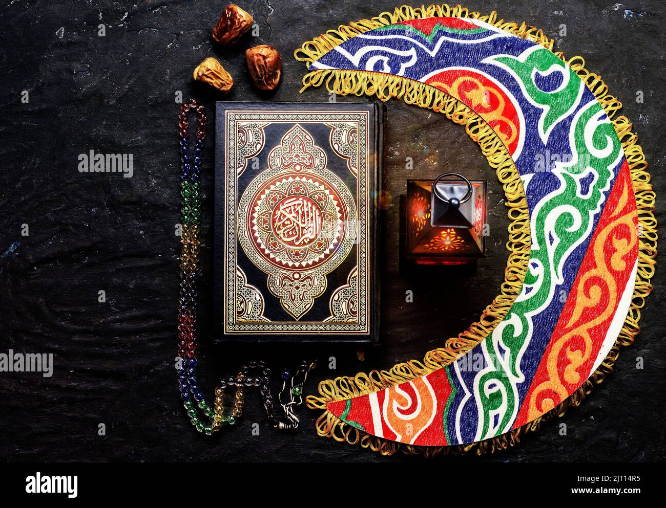 Ramadan concept. The holy book of muslims "Quran" placed with colorful ...
