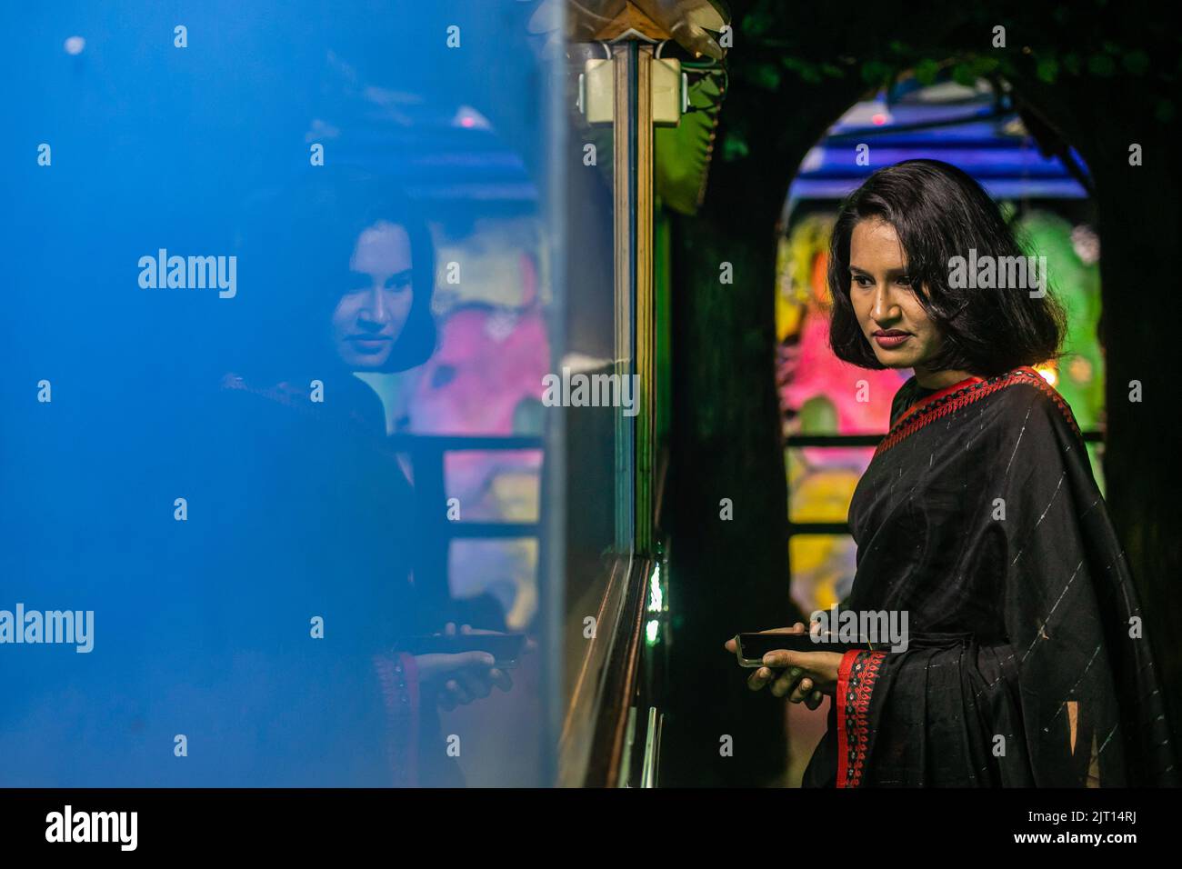 Dhaka, Bangladesh. 22nd Aug, 2022. A visitor looks at the fish in an ...
