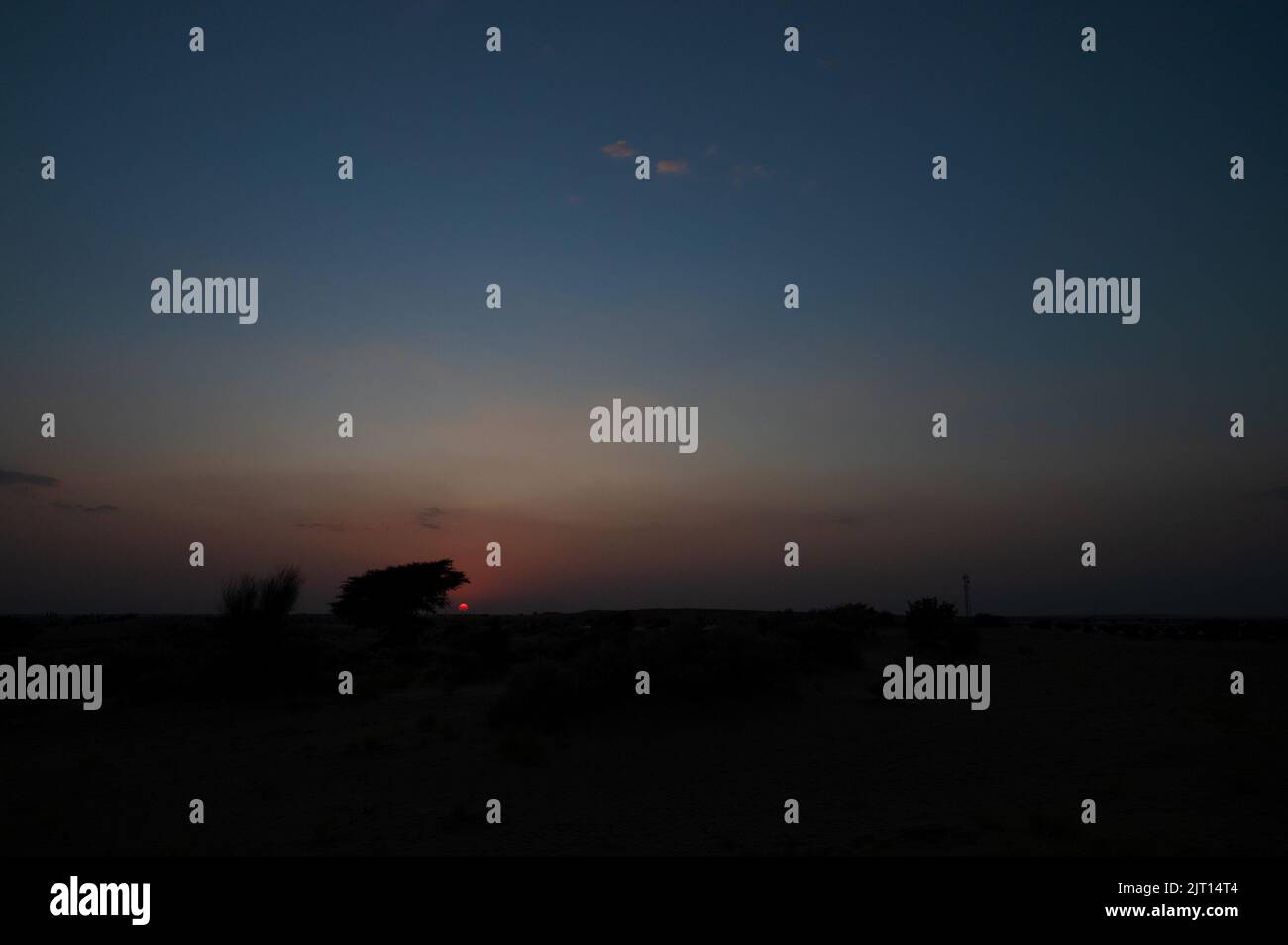 Sun setting at the horizon of Thar desert, Rajasthan, India Stock Photo ...