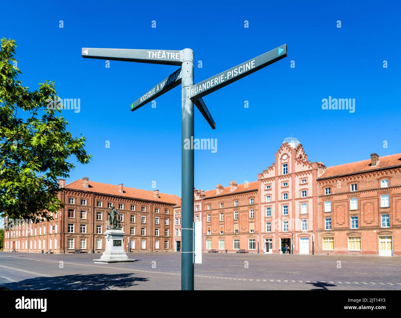 A direction signpost shows the different buildings of the Familistère ...