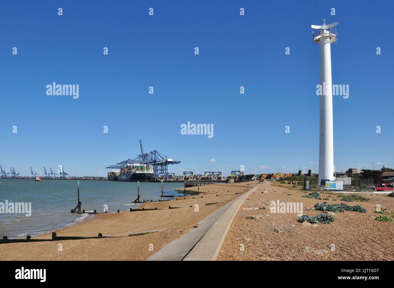 Radar Tower at Landguard Point with dock cranes and ships behind ...