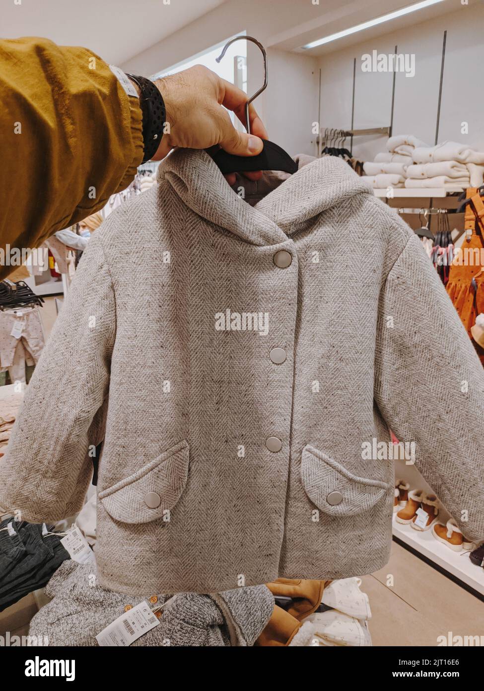 Budva, Montenegro - 18.08.22: Children jacket with a hood on a hanger ...