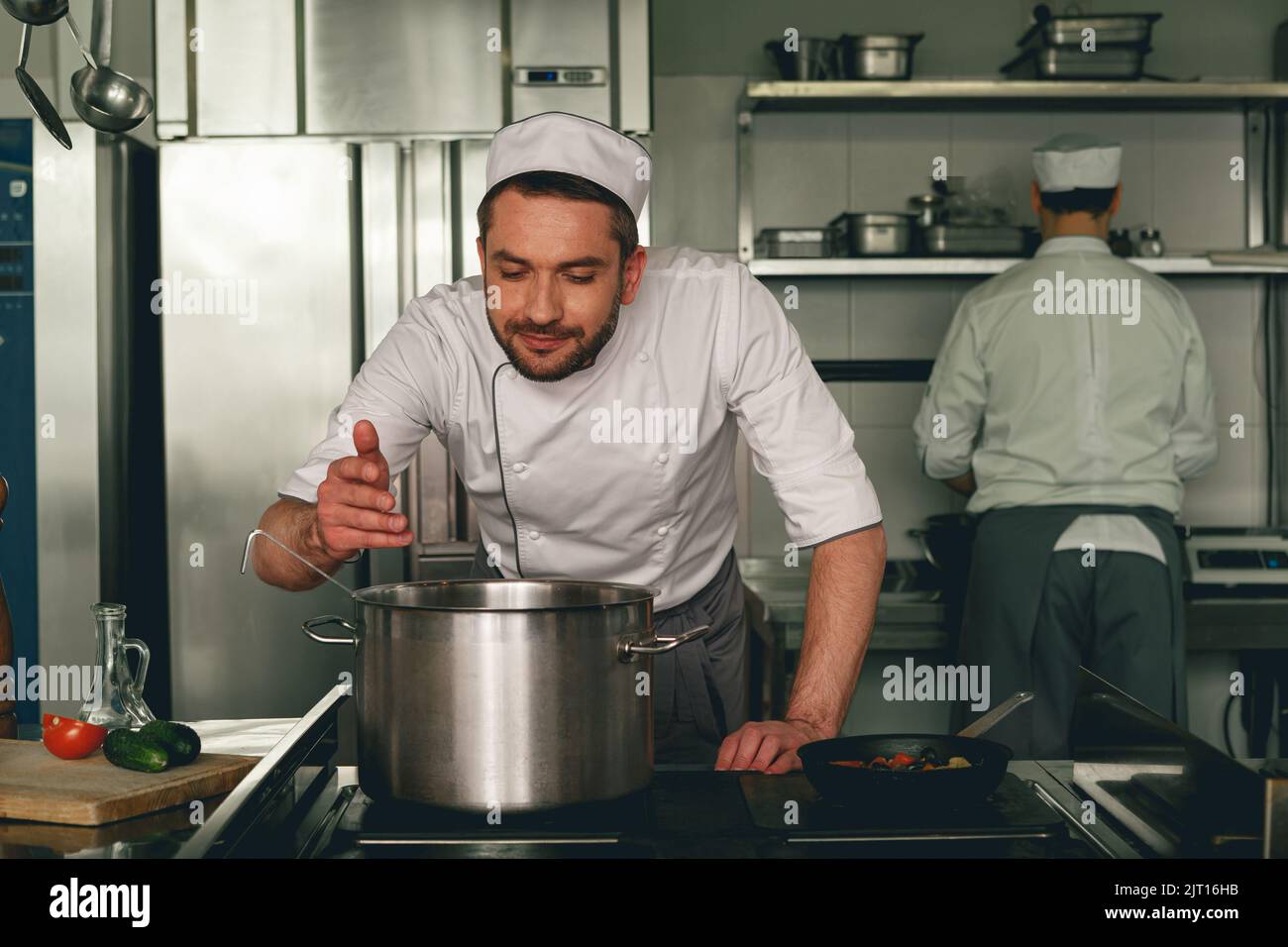 Man japanese restaurant chef cooking in the kitchen and inhaling aroma ...