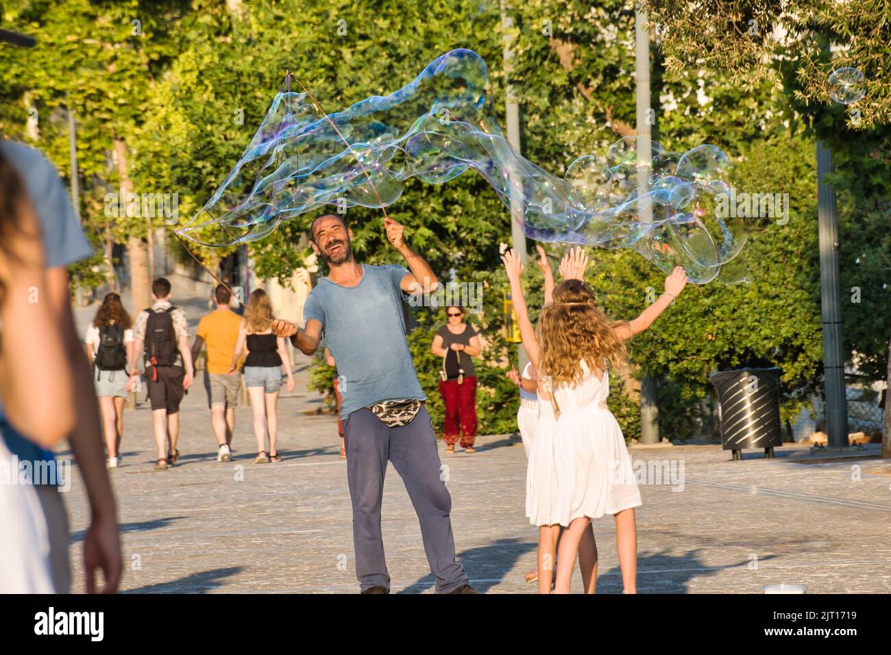 Street artist creates beautiful giant soap bubbles in Athens Stock ...