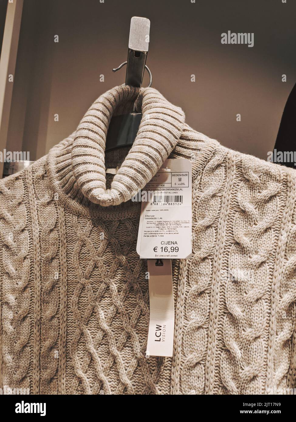 Budva, Montenegro - 01.08.22: Beige knitted sweater with a price tag ...