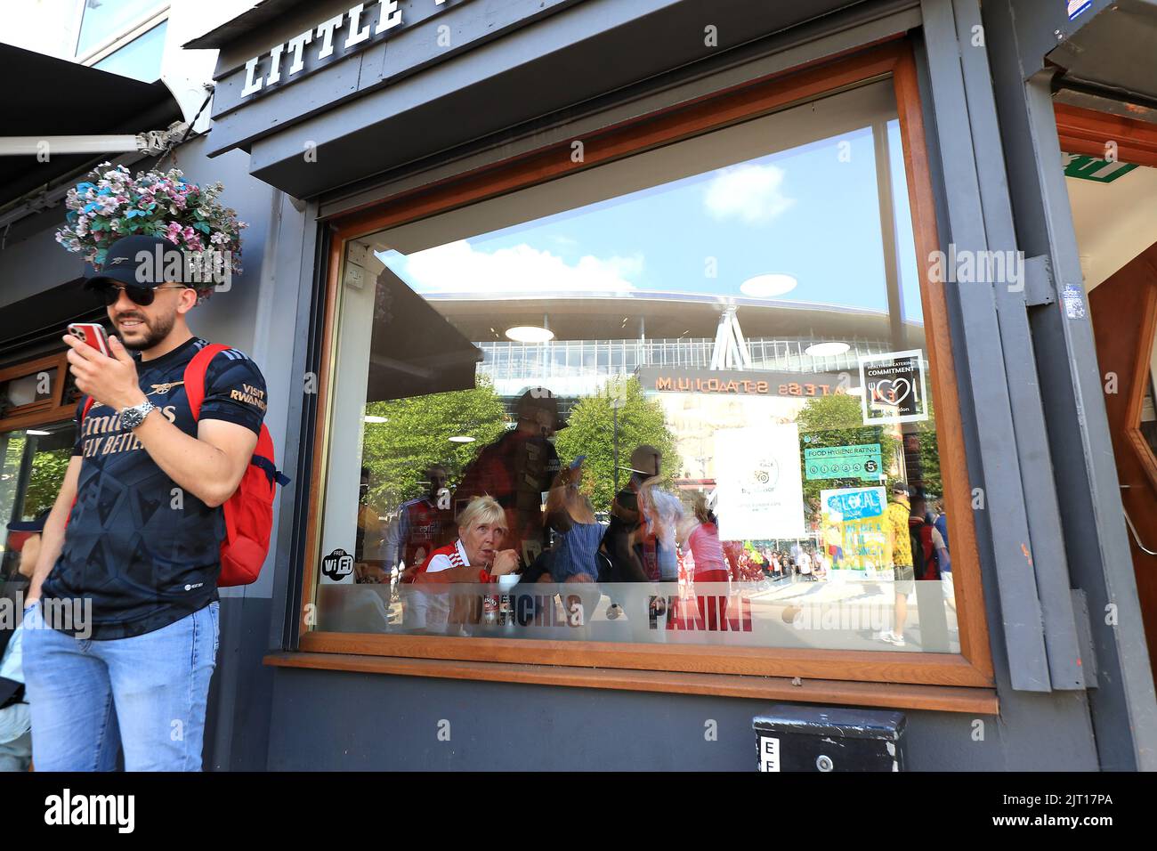 An Arsenal fan outside a cafe before the Premier League match at the ...