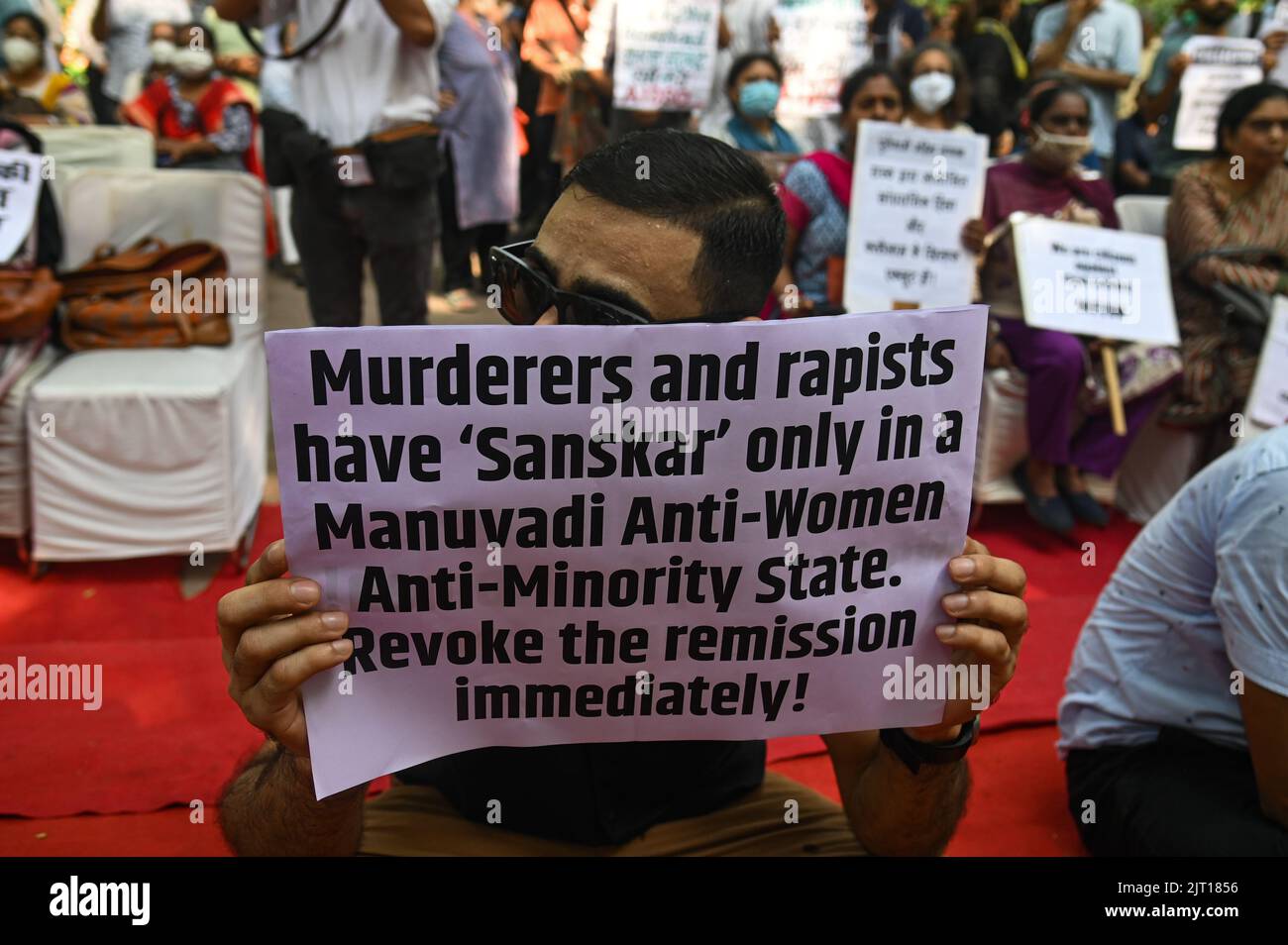 A protestor holds placard in a protest against the release of 11 ...