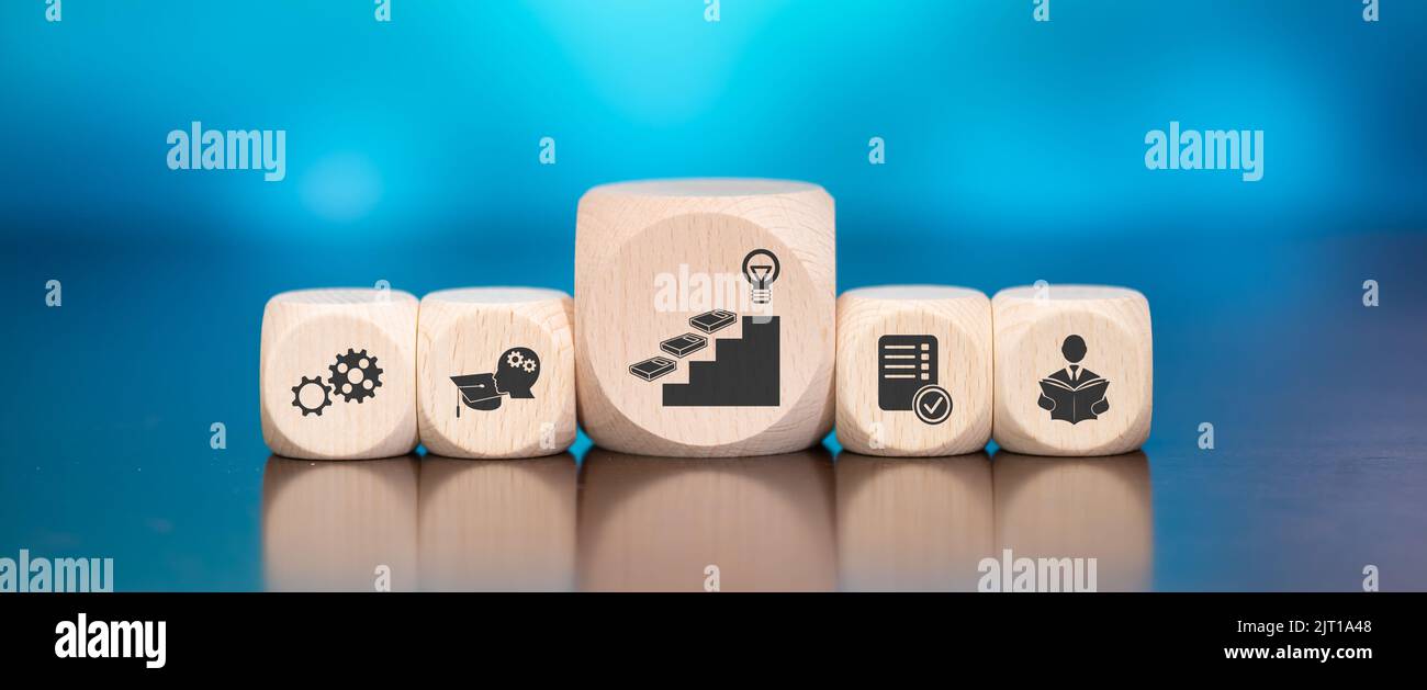 Wooden blocks with symbol of continuing education concept on blue ...