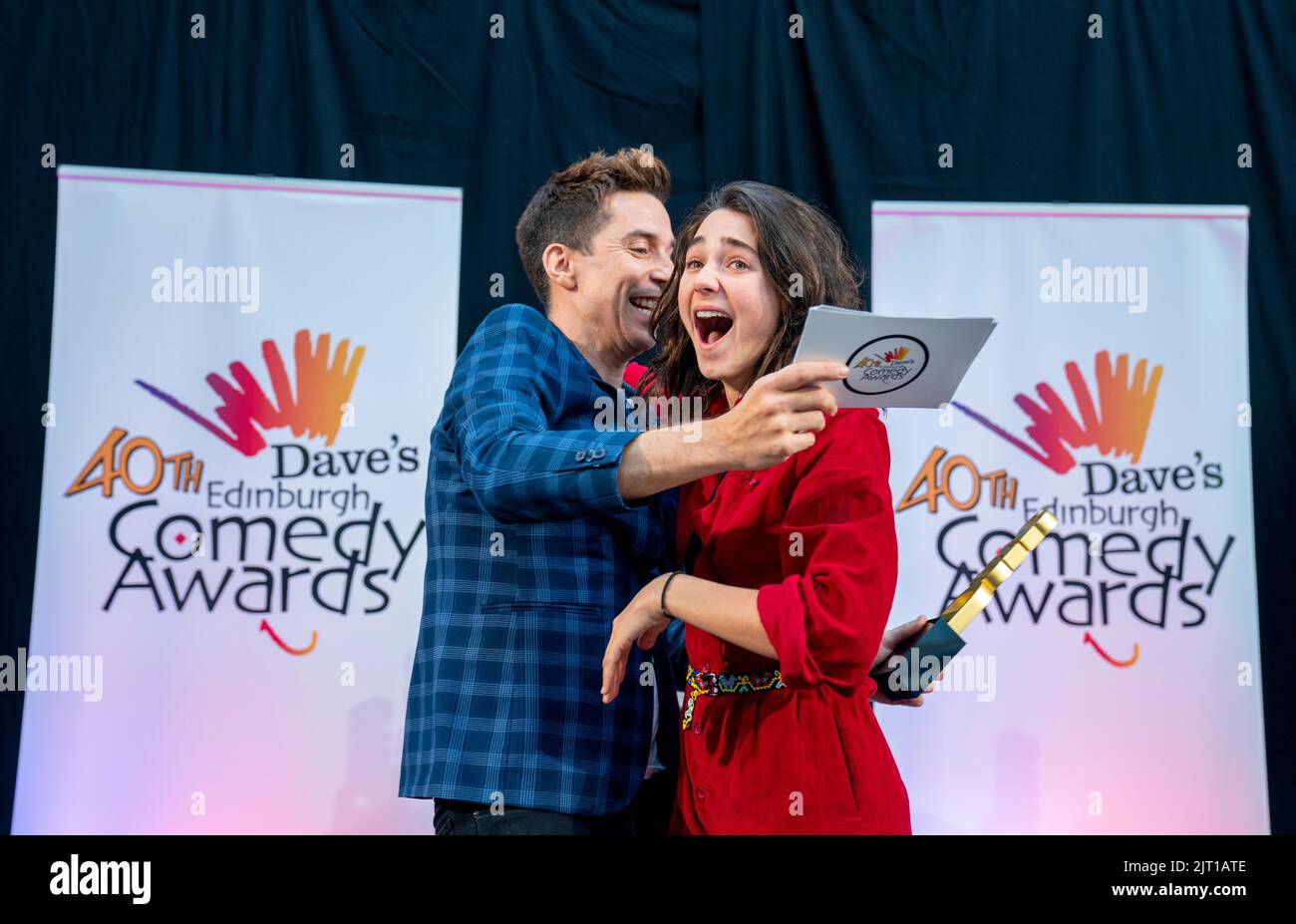 Lara Ricote, with Russell Kane (left), reacts after winning the Dave's ...