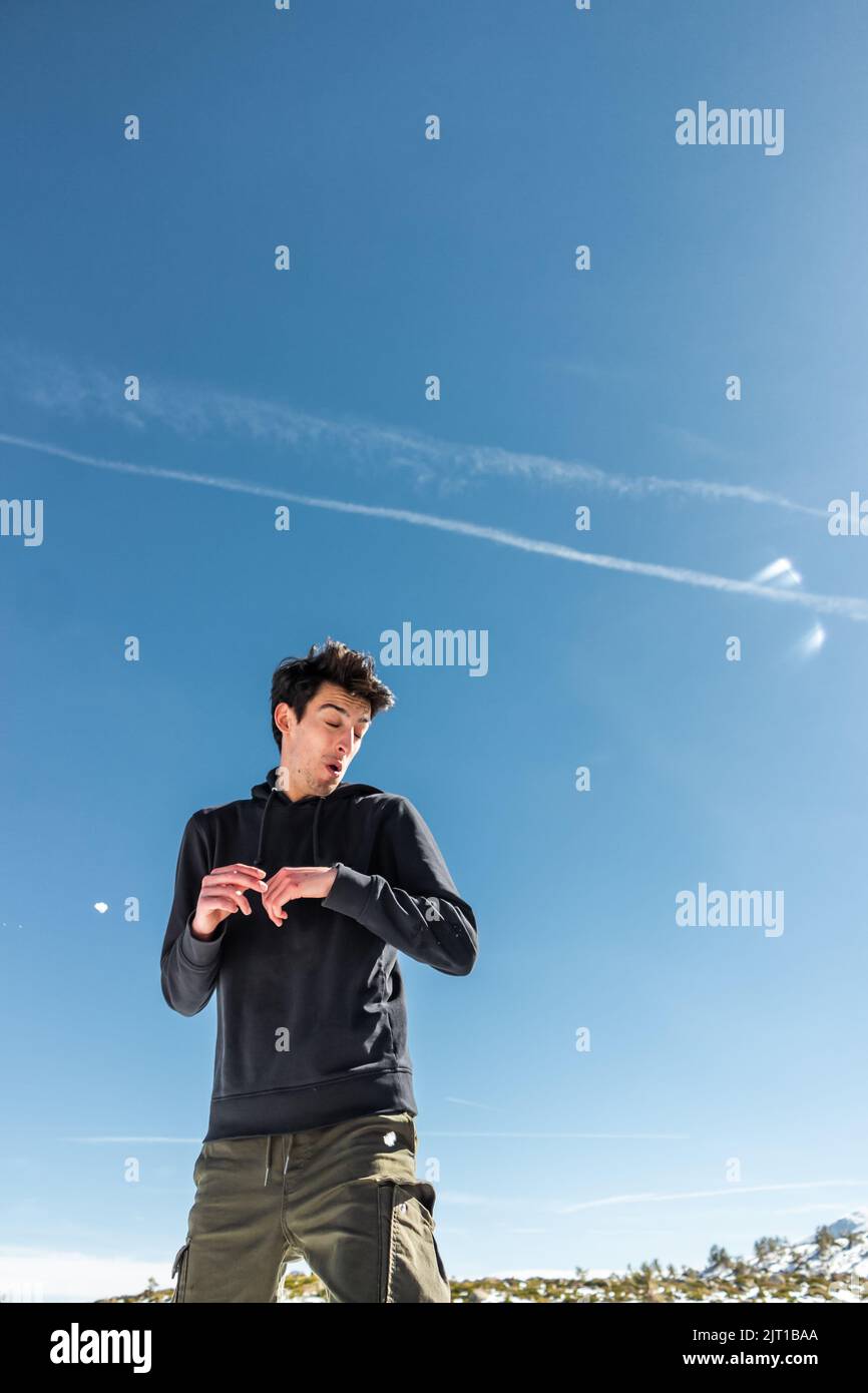 Caucasian handsome man fighting in the middle of a snowy place. He is ...