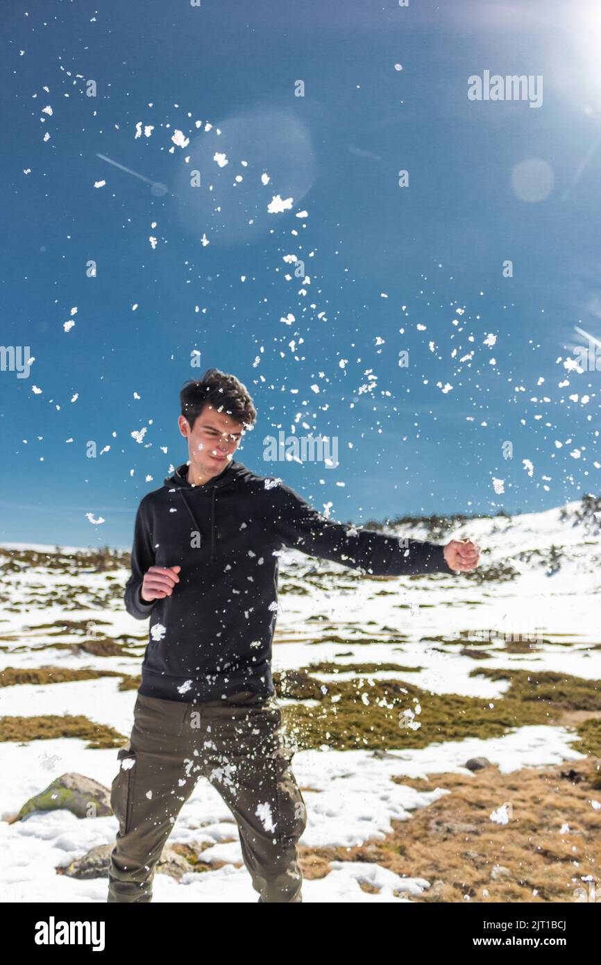 Caucasian handsome man fighting in the middle of a snowy place. He is ...