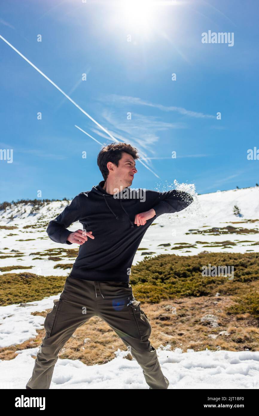 Caucasian handsome man fighting in the middle of a snowy place. He is ...
