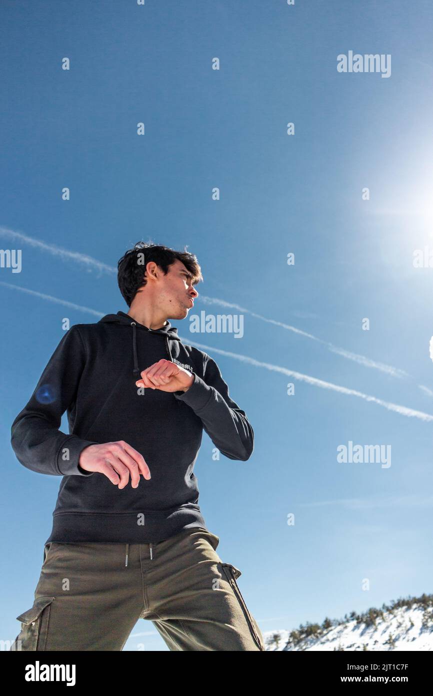 Caucasian handsome man fighting in the middle of a snowy place. He is ...