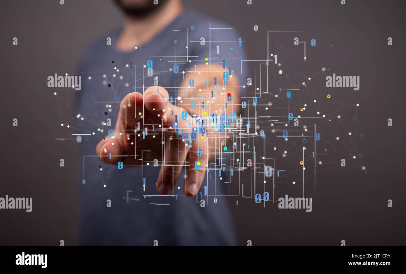 A man tapping on a floating digital render of a binary code network ... A man tapping on a floating digital render of a binary code network ...
