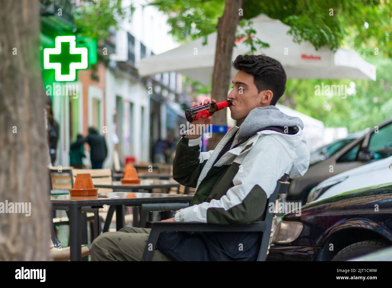 handsome masculine man with a coat sitting at a restaurant table ...