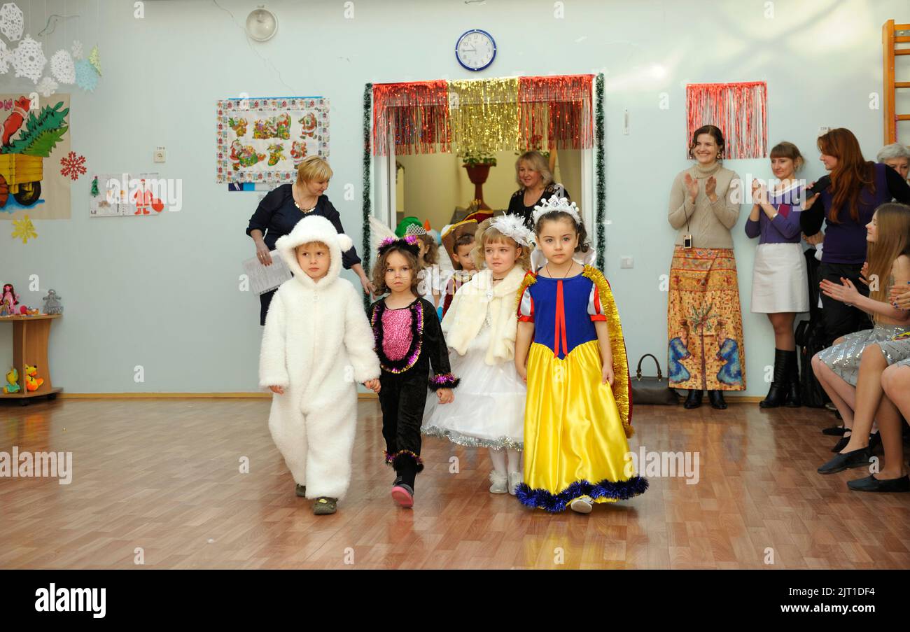 Children in carnival costumes singing song in the kindergarten, New ...