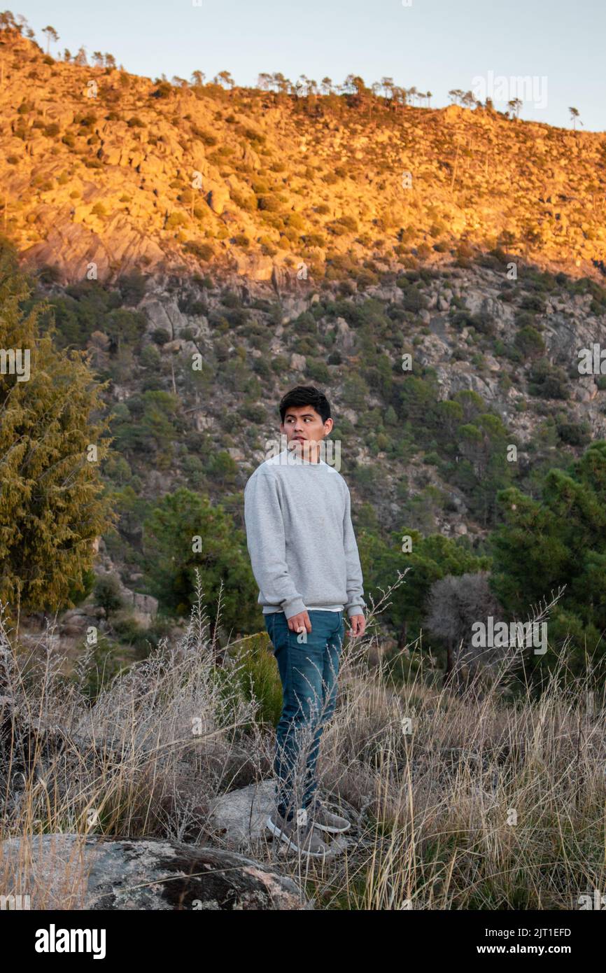 Latin american handsome guy standing in rock in nature. With the ...