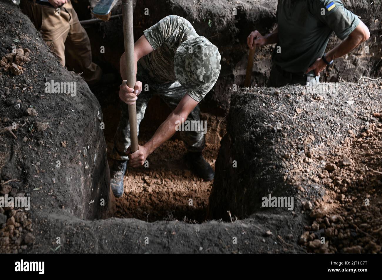 Ukrainian service members dig and prepare trenches and fighting ...