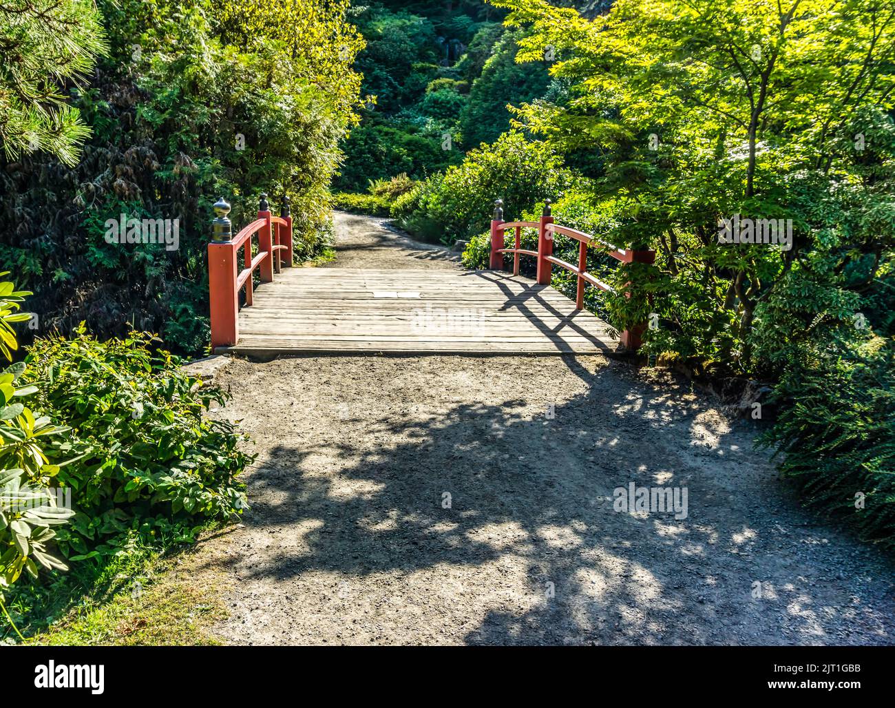 A red walking bridge and path in a garden in Seattle, Washington Stock ...