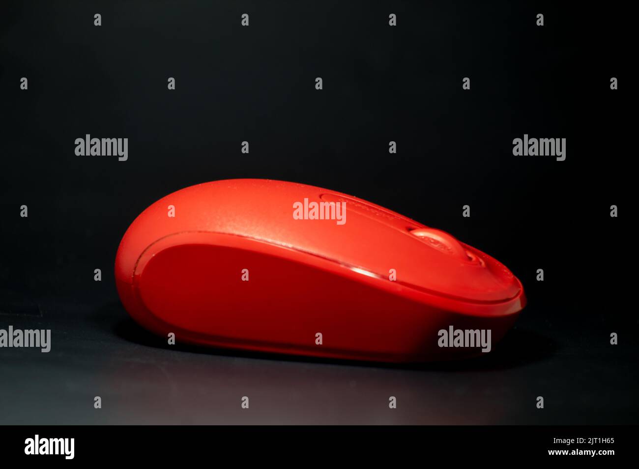 Red wireless mouse on the isolated black background Stock Photo - Alamy