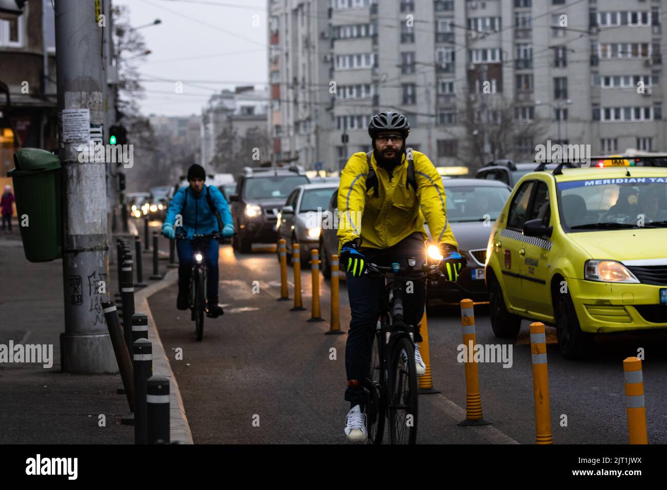 Riding a bicycle on the city streets. Commute to work in Bucharest ...