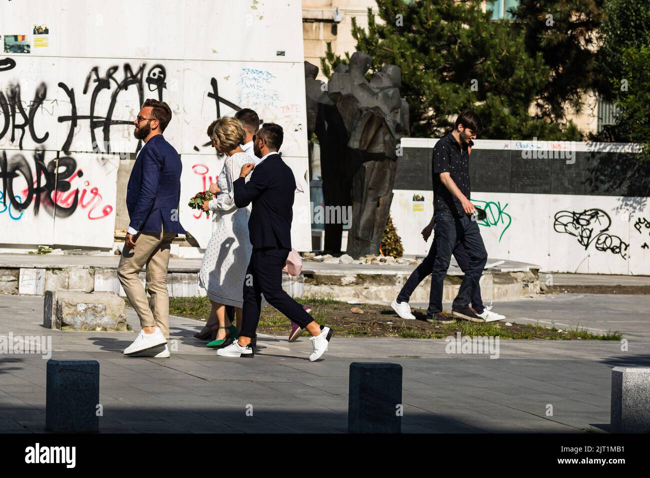 People and tourists wander the streets of the Bucharest Old Town ...