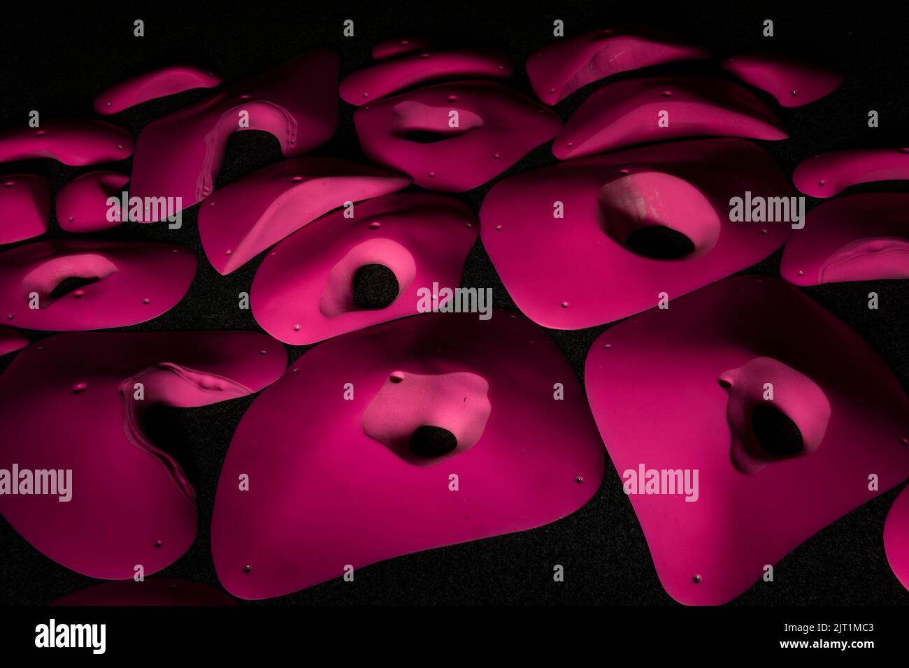 The pink climbing holds in the bouldering gym Stock Photo - Alamy