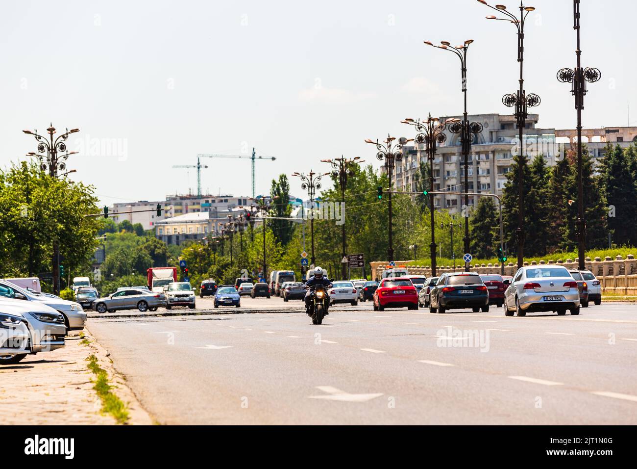 Biker on a motorcycle in traffic at rush hour in downtown area of the ...