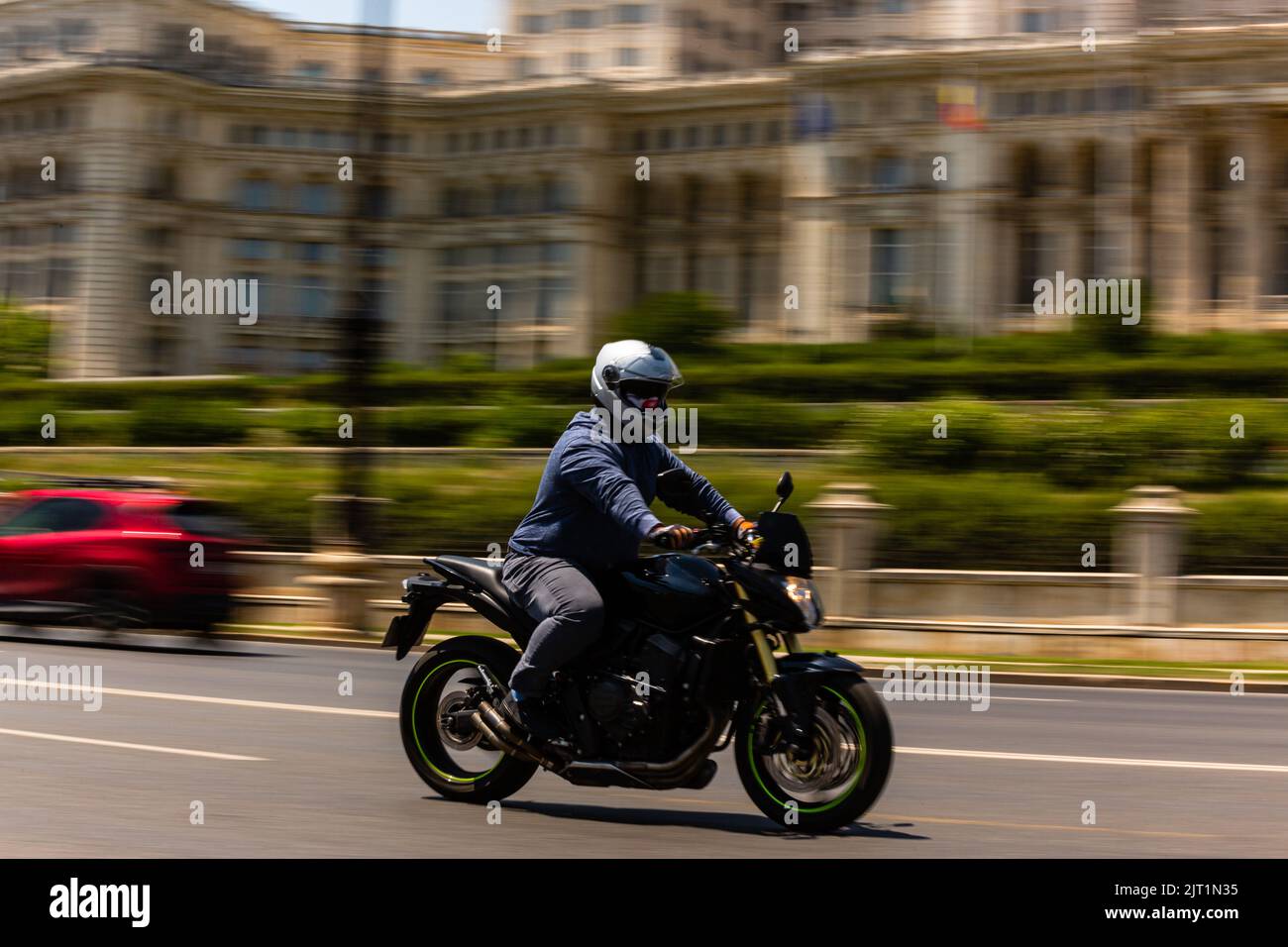 Biker on a motorcycle in traffic at rush hour in downtown area of the ...