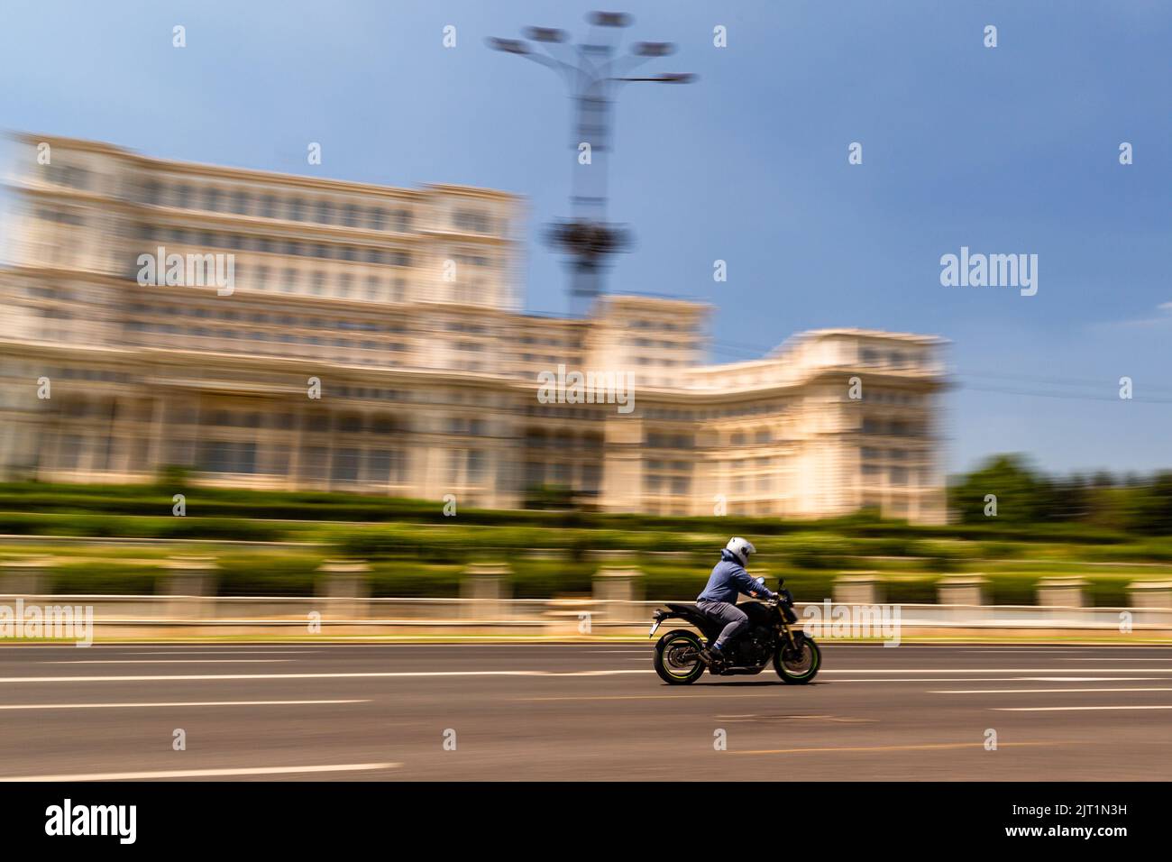 Biker on a motorcycle in traffic at rush hour in downtown area of the ...