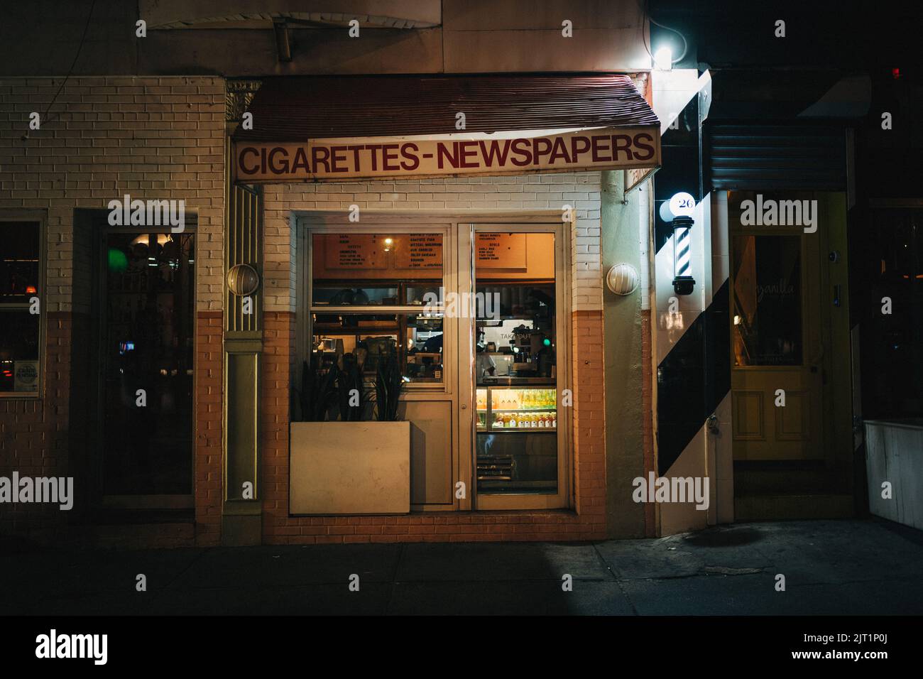 Cigarettes - Newspapers sign at night, in the Lower East Side ...