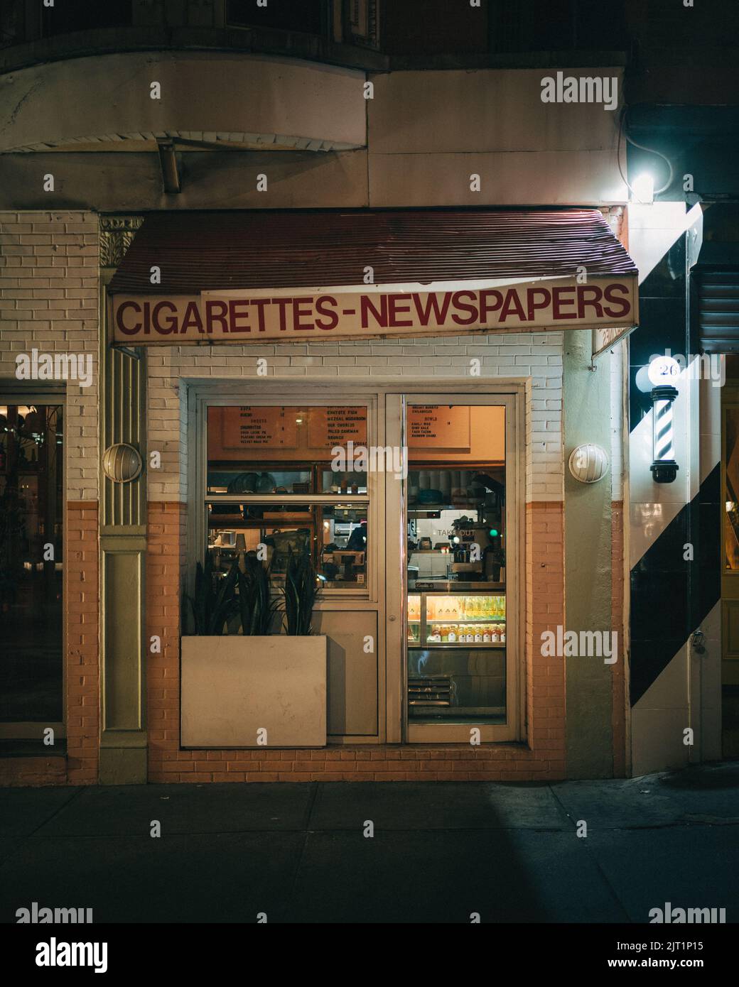 Cigarettes - Newspapers sign at night, in the Lower East Side ...