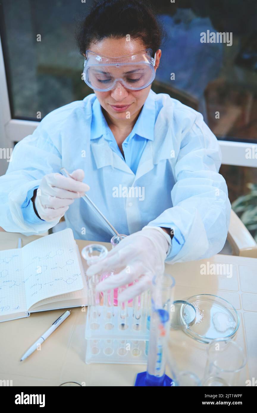 Multi-ethnic woman, laboratory technician or assistant in white lab ...