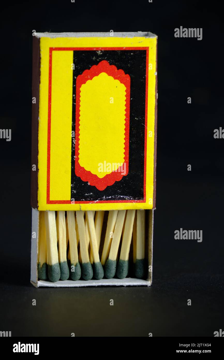 Open and full matchbox on black background Stock Photo - Alamy
