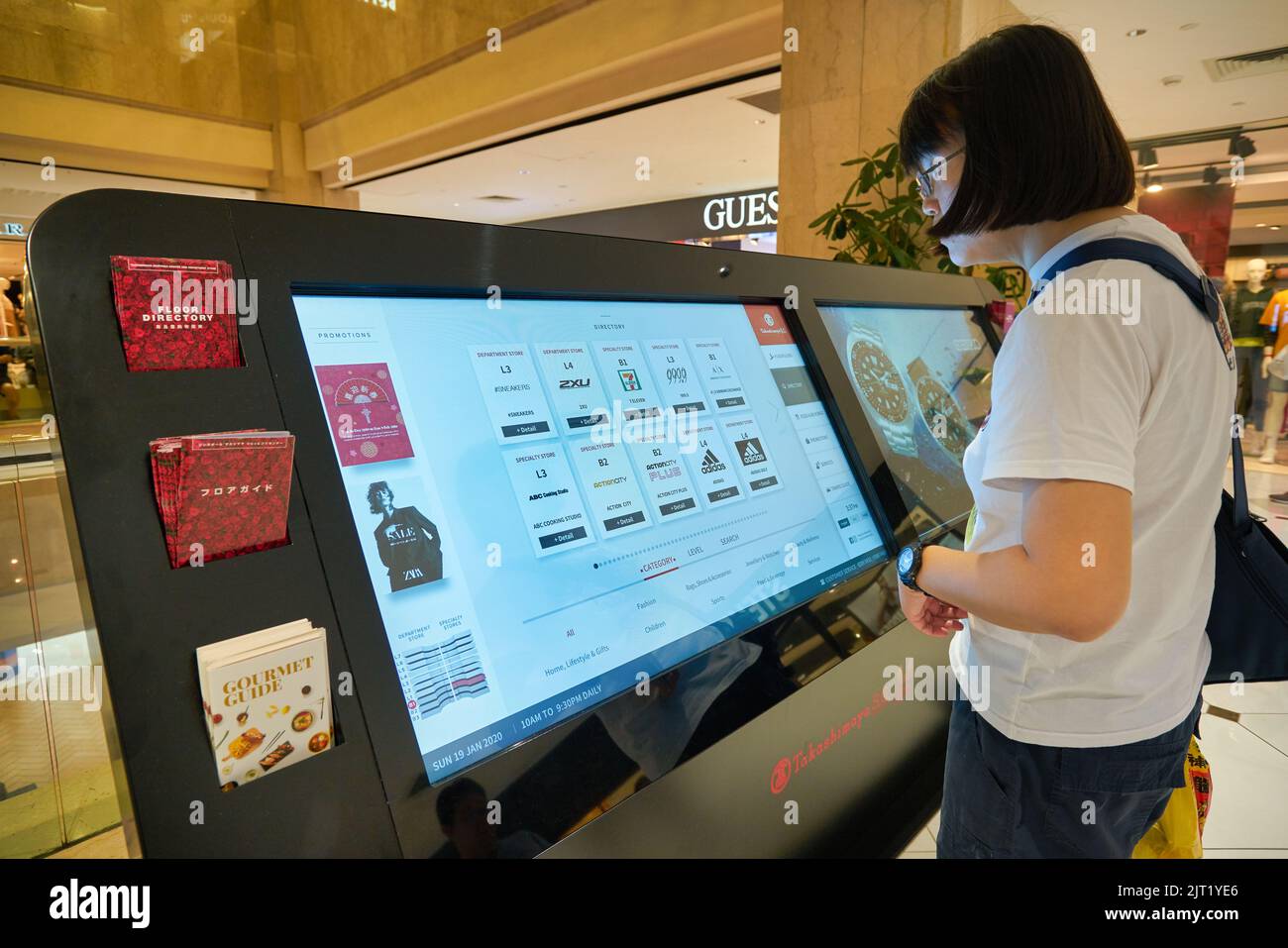 SINGAPORE - CIRCA JANUARY, 2020: woman use interactive touch screen ...