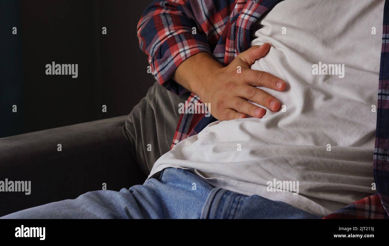 Pain in the side. Man suffers from liver pain Stock Photo - Alamy