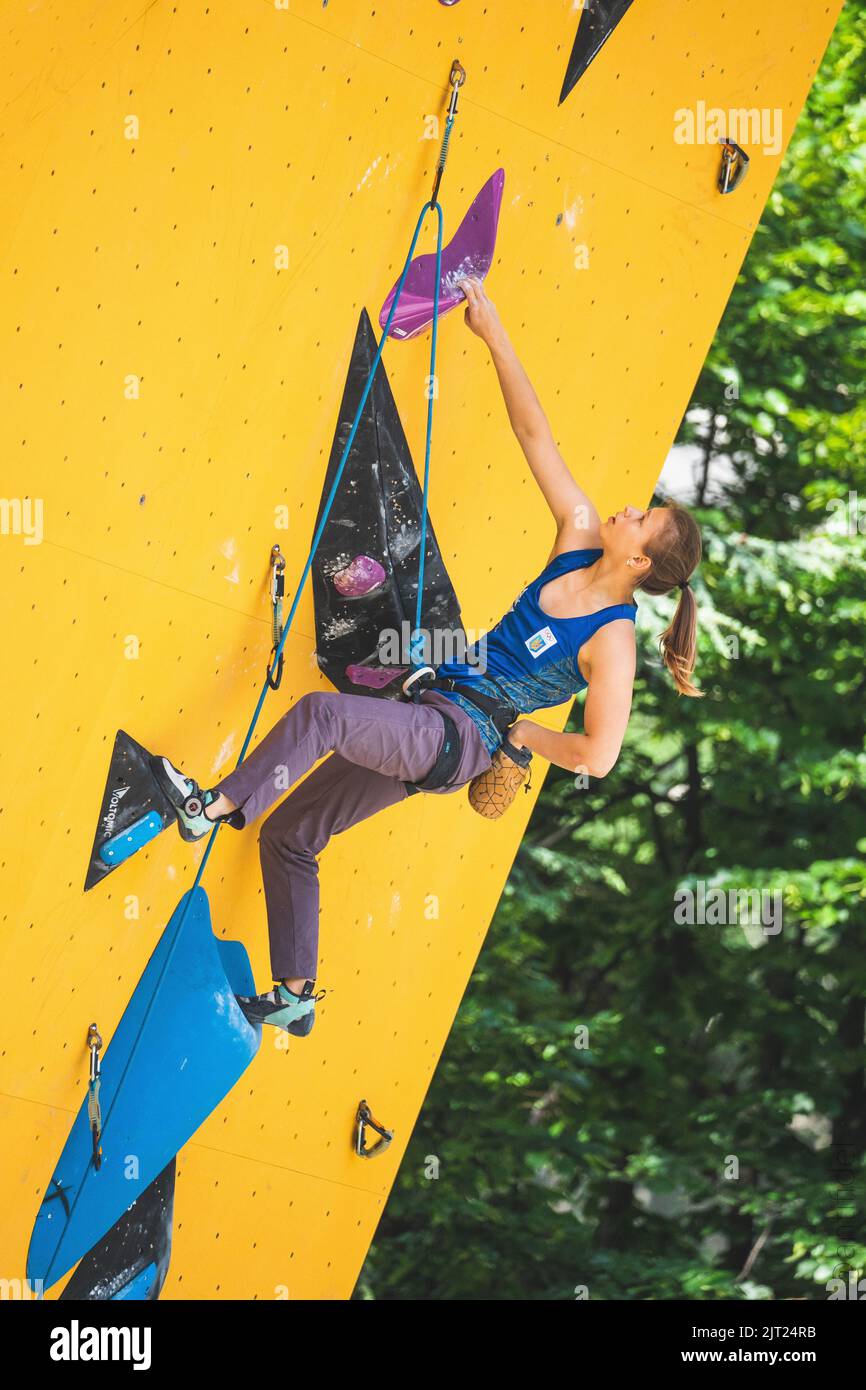A vertical shot of a young pretty Ukrainian lady athlete climber ...