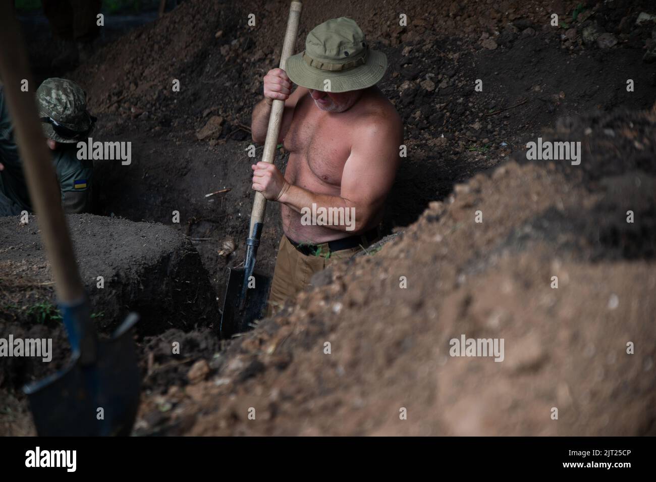 A Ukrainian soldier digs a trench in the Donbas region of Ukraine. As ...