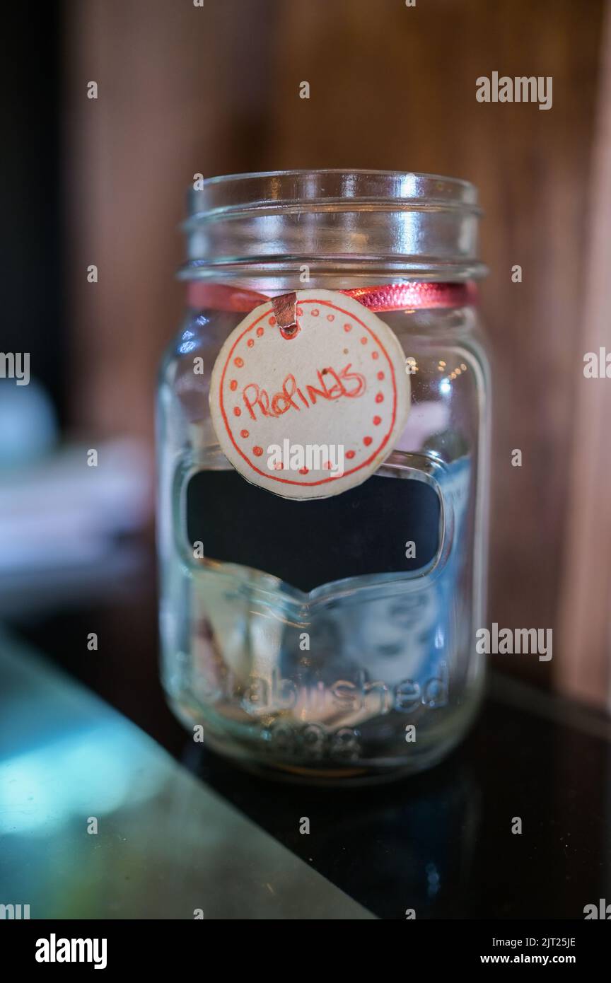 Tip pot at Le Sucre Bistró French restaurant in Cali, Colombia Stock ...