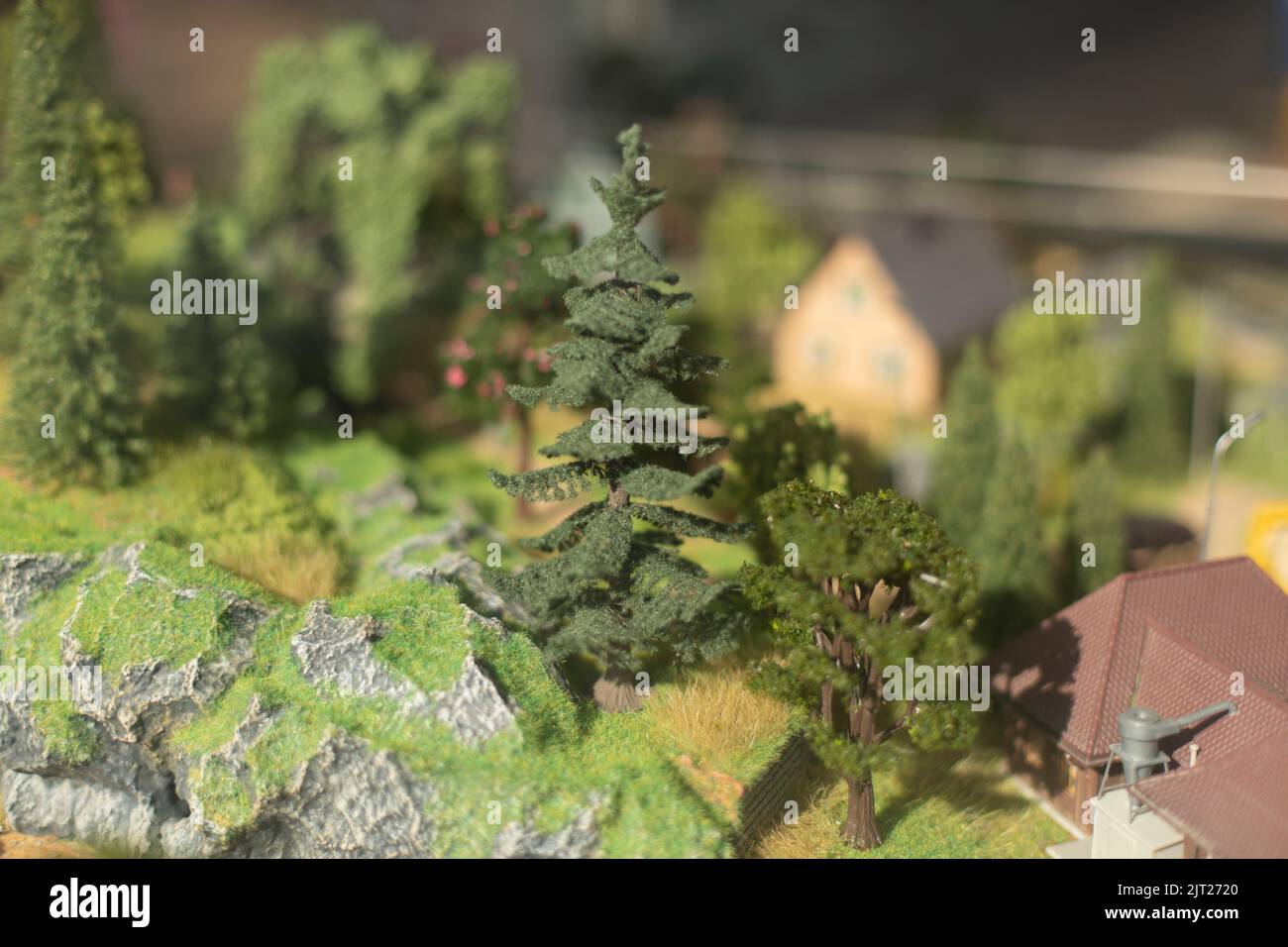 Town in mountains in miniature. Trees made of plastic. Toy land. Game ...