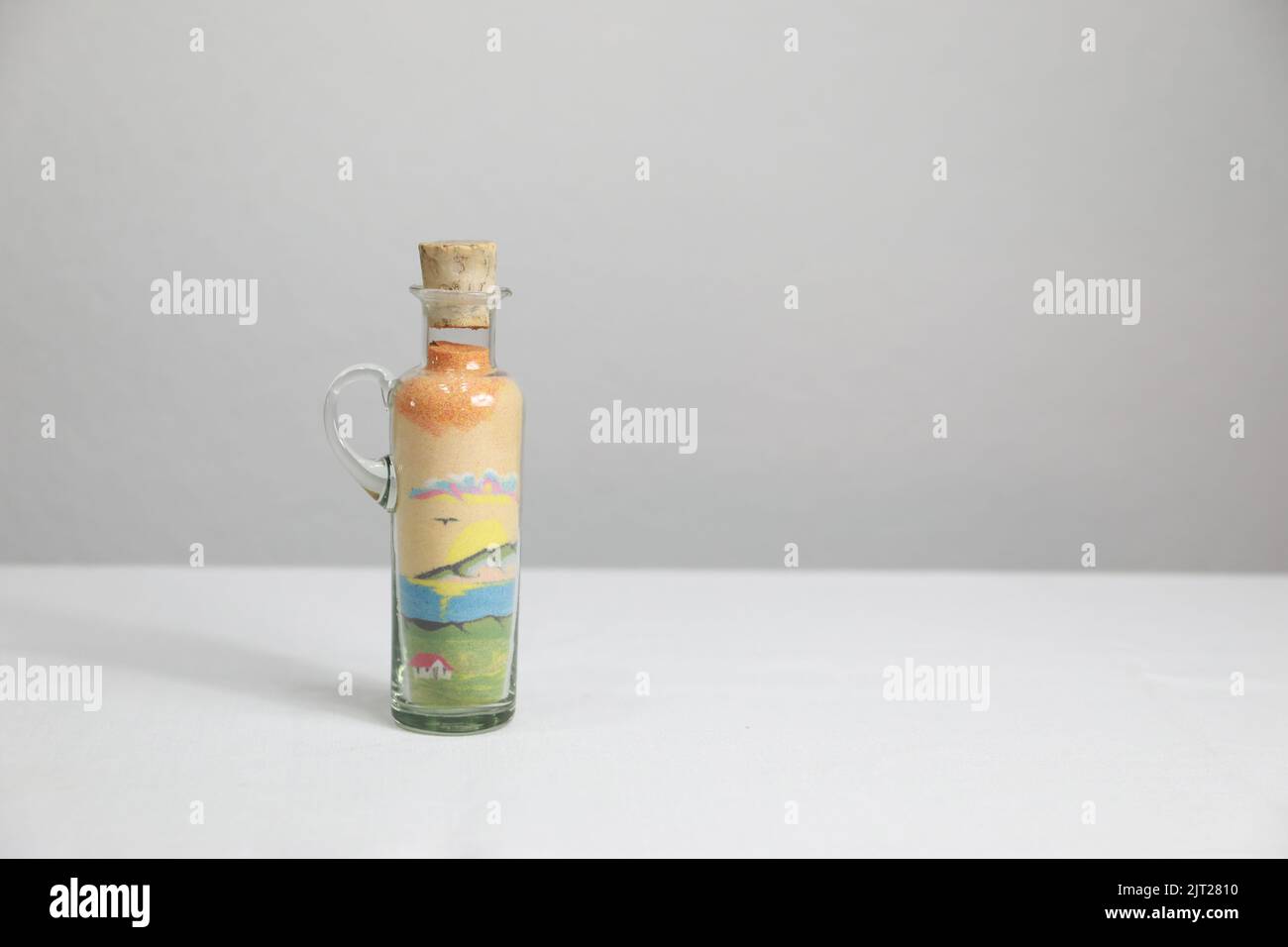 A colorful sand in a bottle with a landscape design Stock Photo - Alamy