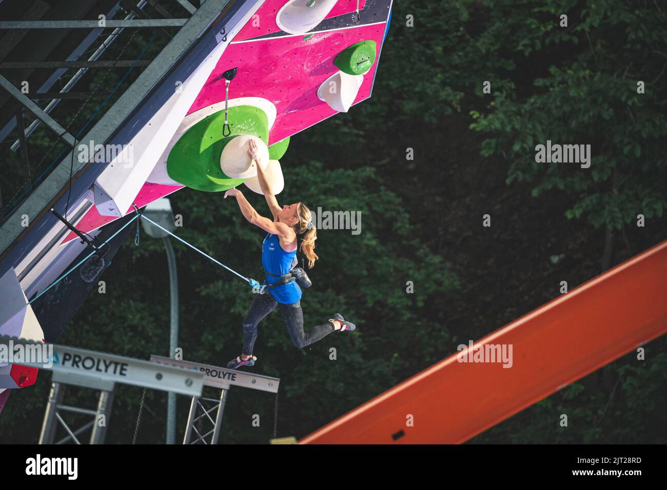 An athlete jumping on the final route of the IFSC lead world cup Stock ...