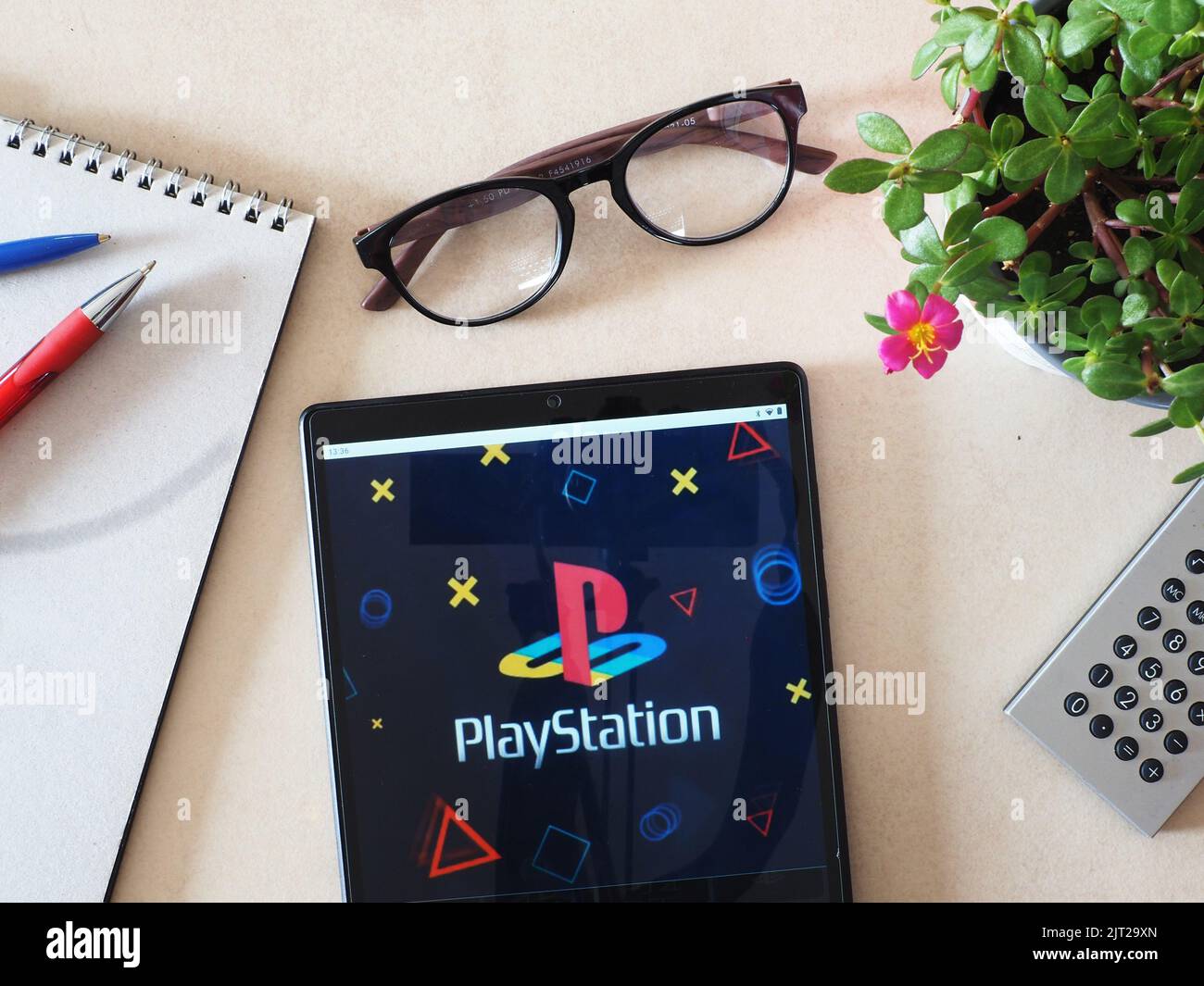 In this photo illustration, a PlayStation logo seen displayed on a ...