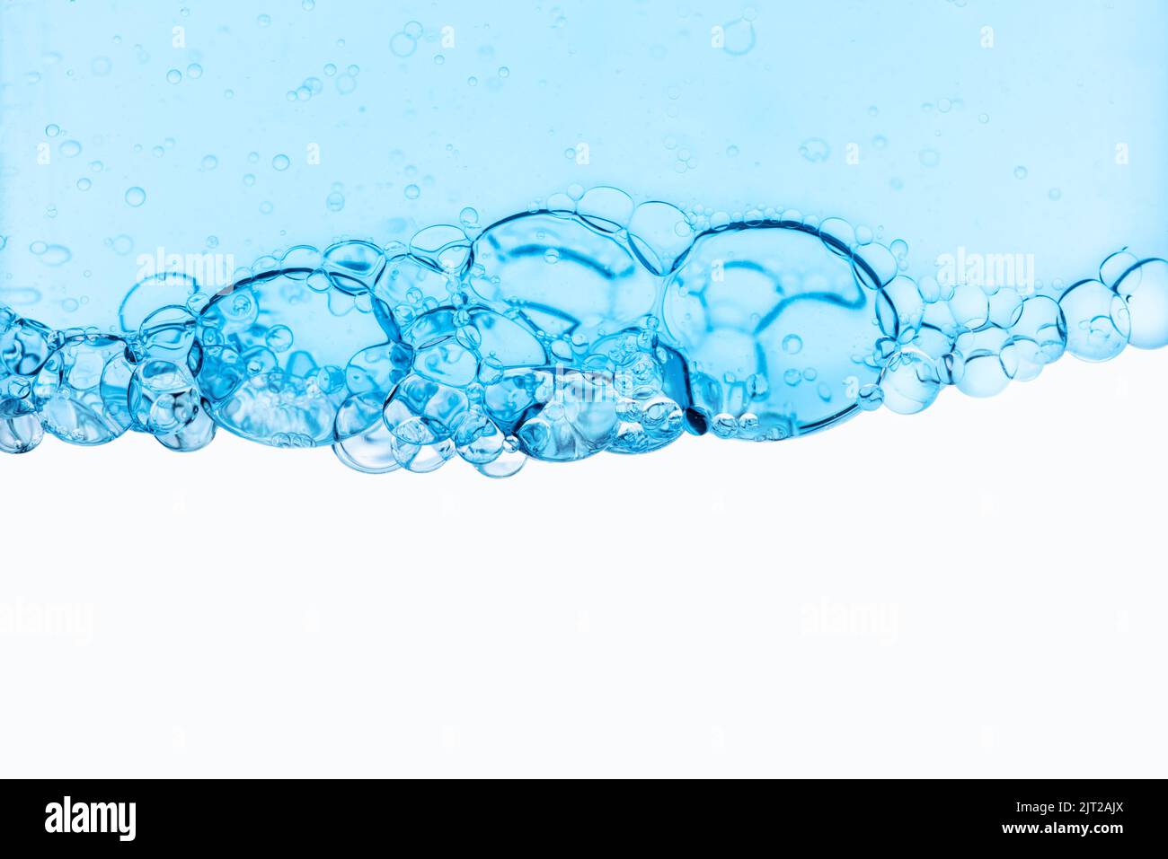 Transparent background with blue bubbles. Backdrop with effervescent bubbles of gas, oil in the ...