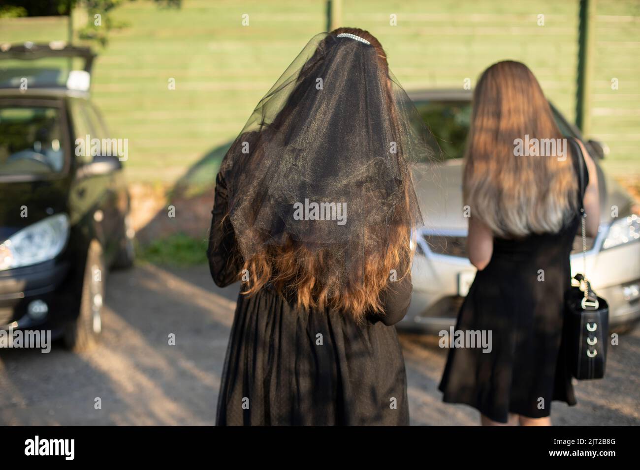 Girls in parking lot. Girls in black dresses. Details of ceremony ...