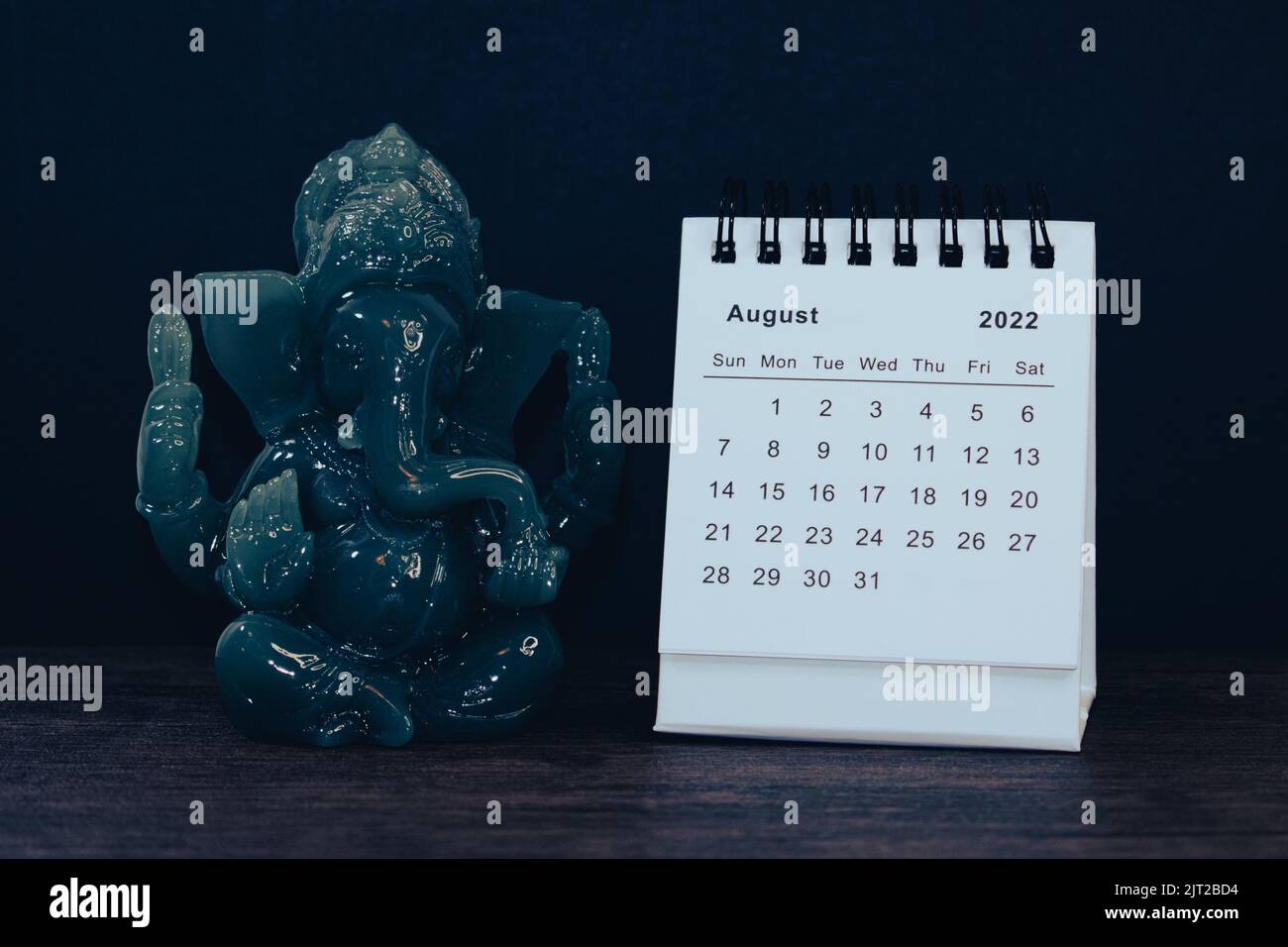 Small white desk calendar next to jade Ganesh statue background Stock ...