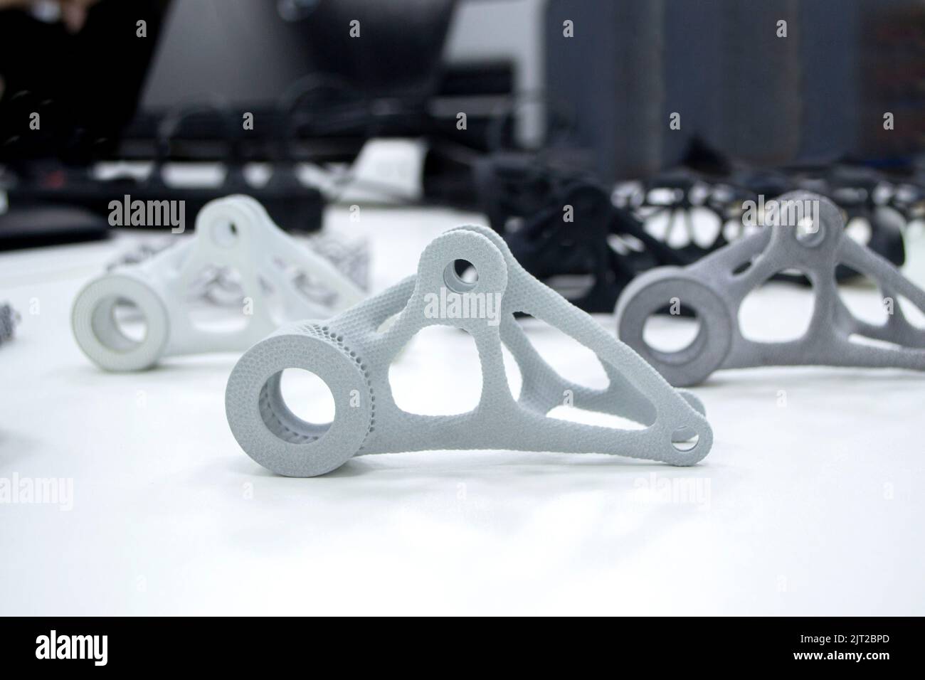 Black white gray models printed on 3D printer in laboratory office. Objects printed on 3D ...