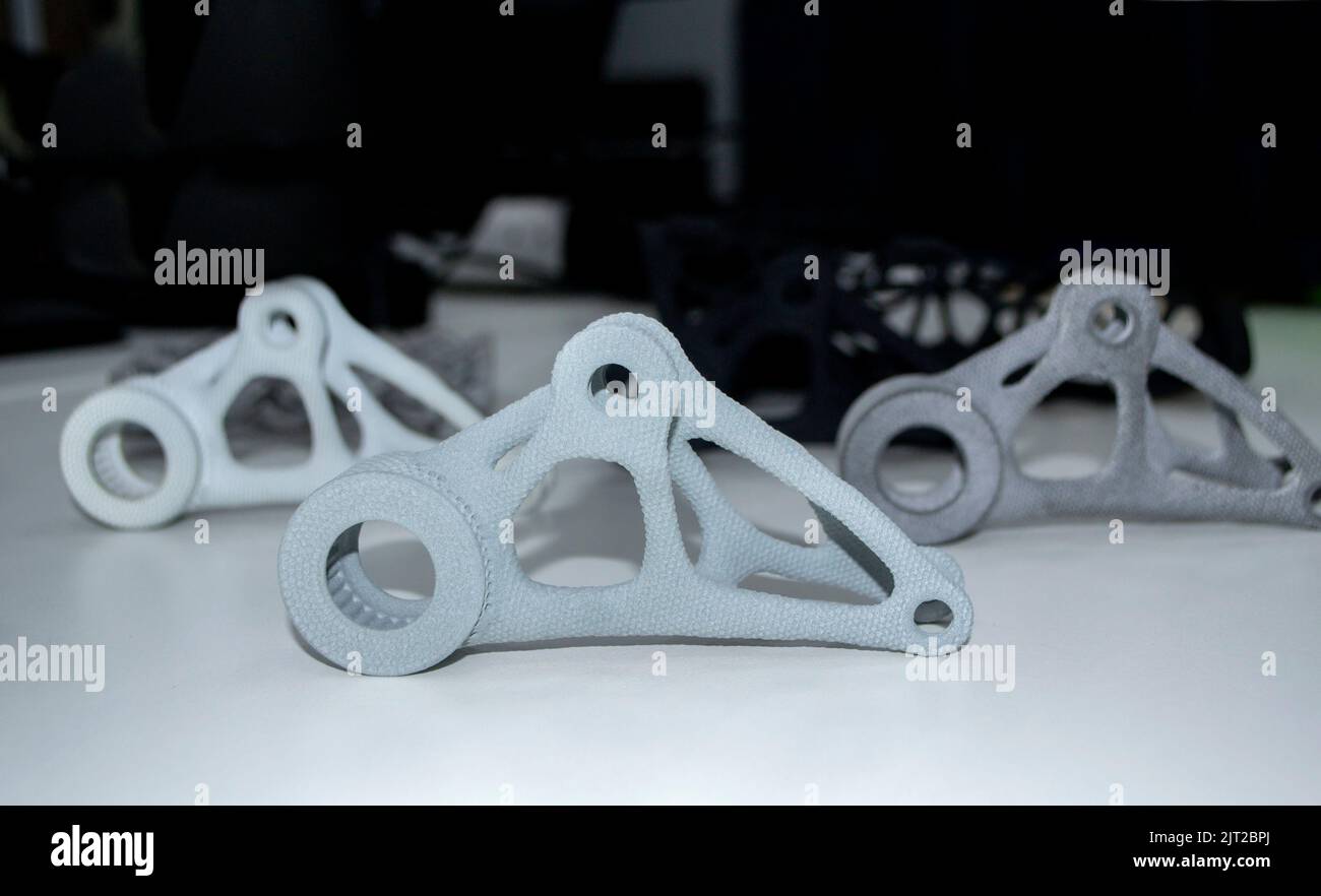 Black white gray models printed on 3D printer in laboratory office. Objects printed on 3D ...