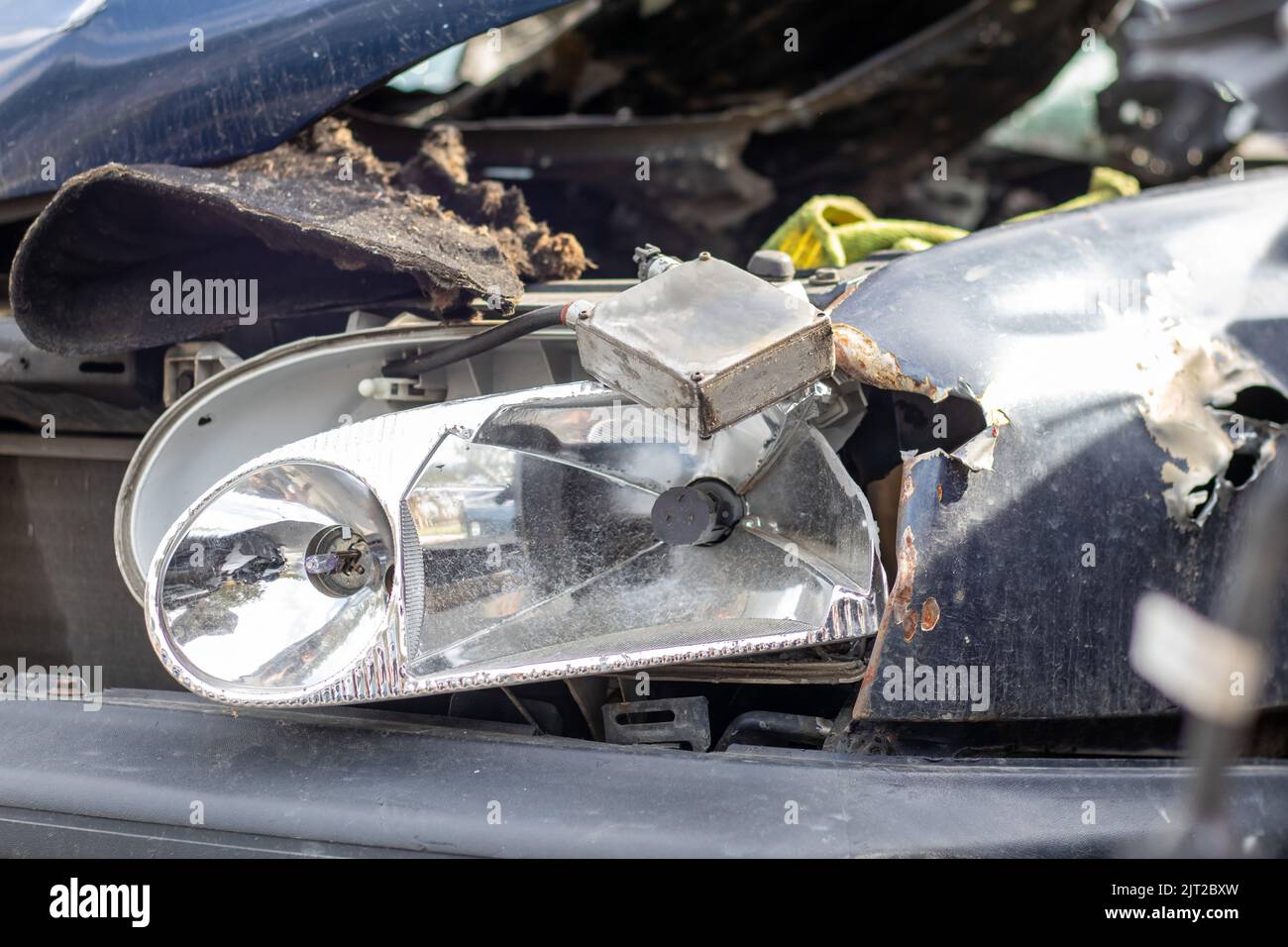 Broken headlights as a result of a collision. Broken blue car after an ...