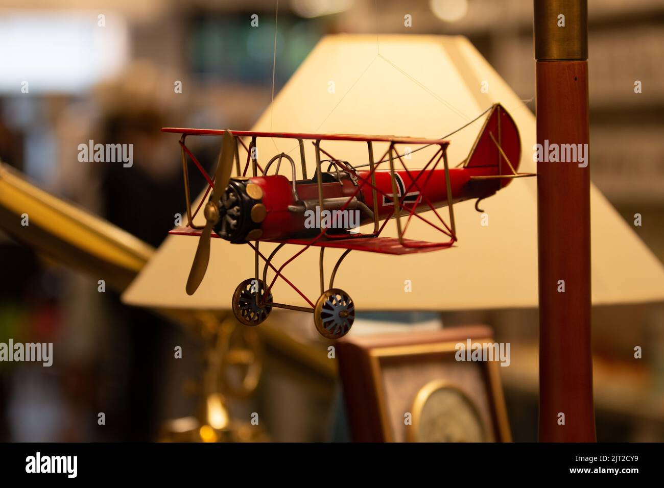A miniature hanging red model airplane Stock Photo - Alamy